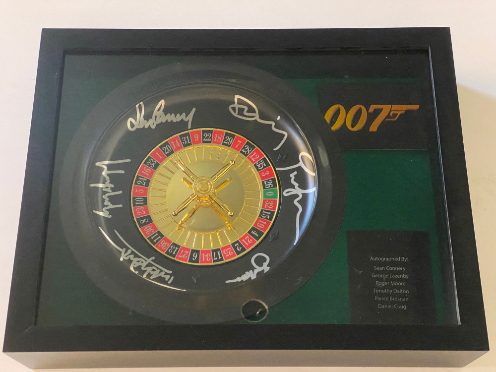 #M052 - James Bond cast signed roulette wheel | MAG Auctions